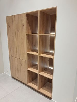 Wall of light wood melamine columns opening to two hinged... - 84995376 ...